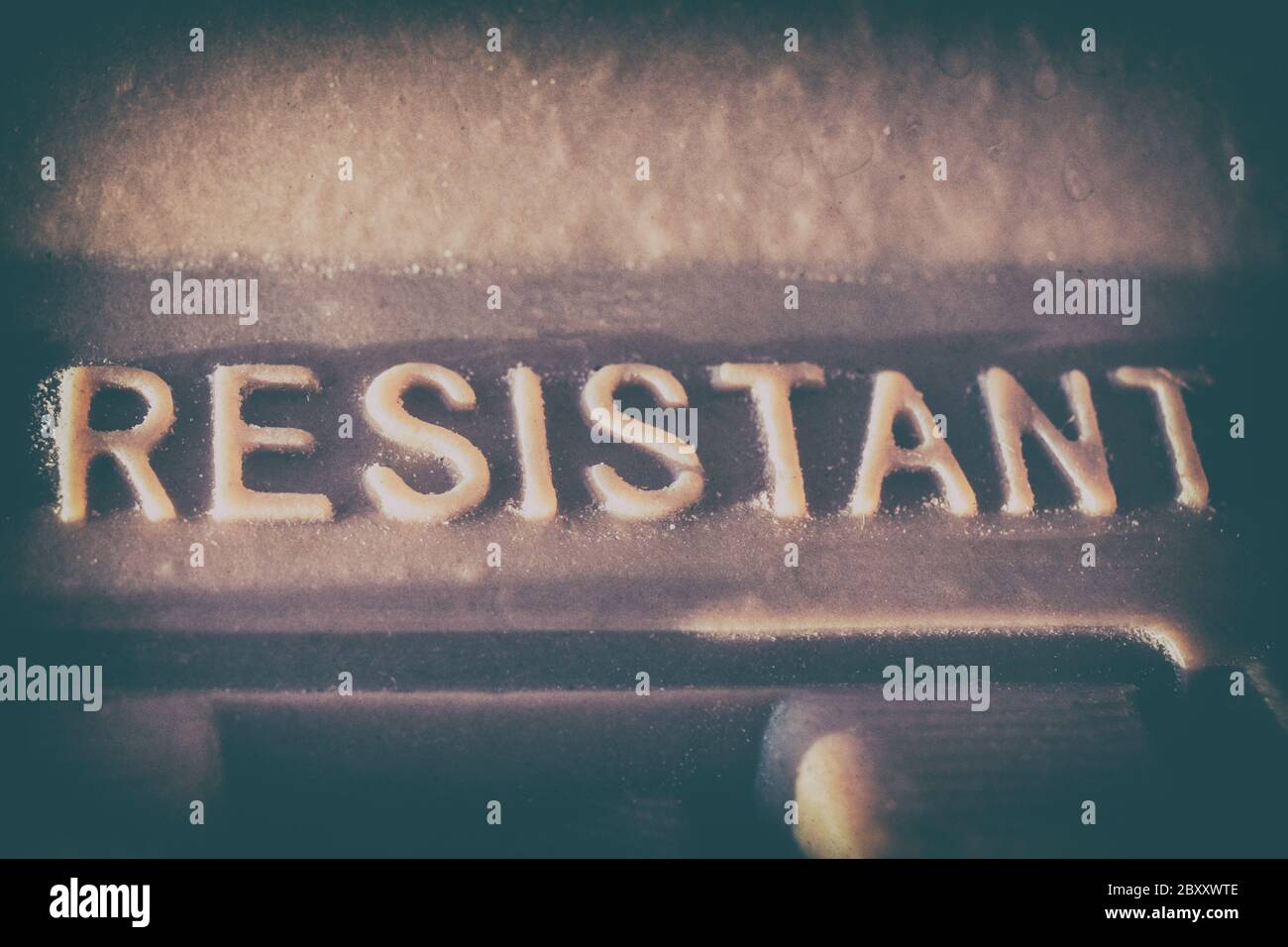The word "RESISTANT" written in vintage press stamp Stock Photo - Alamy