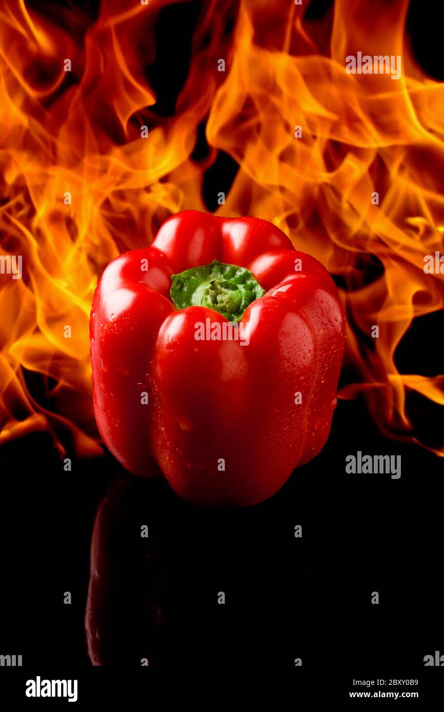 Pepper with fire background Stock Photo - Alamy