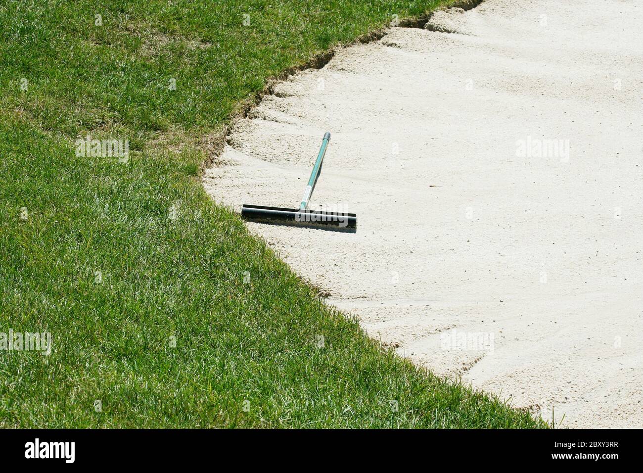 A Sand trap rake in a bunker Stock Photo - Alamy
