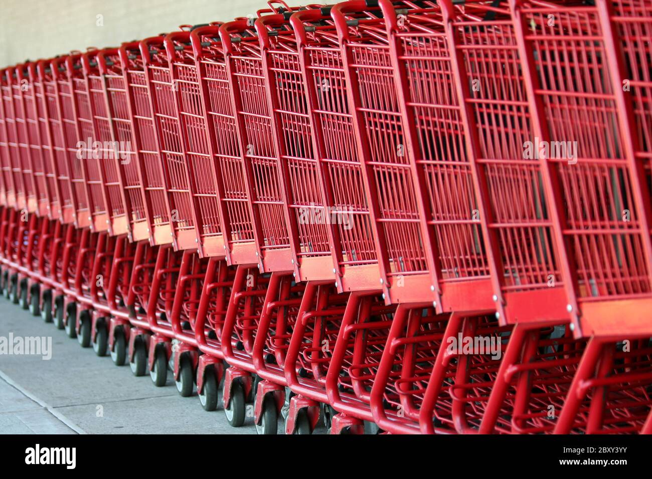 A Row of red metal shopping carts Stock Photo - Alamy