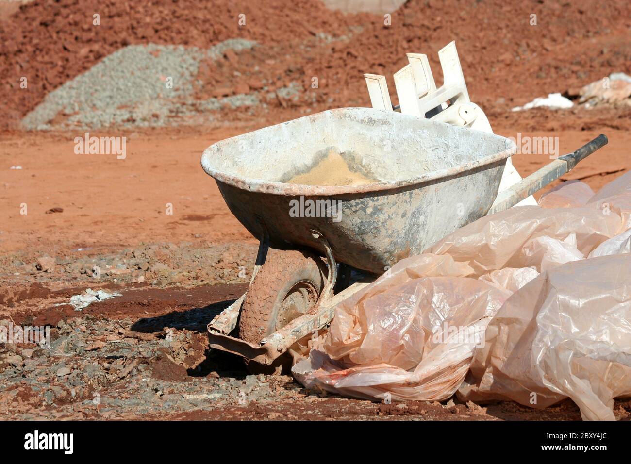 A wheelborrow at a construction site Stock Photo - Alamy