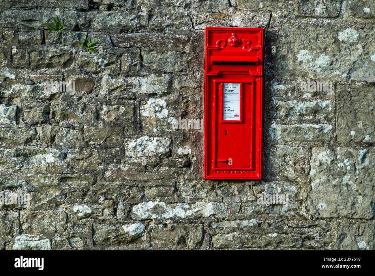 Red mailbox set into a stone wall in Richmondshire, England, UK Stock ...