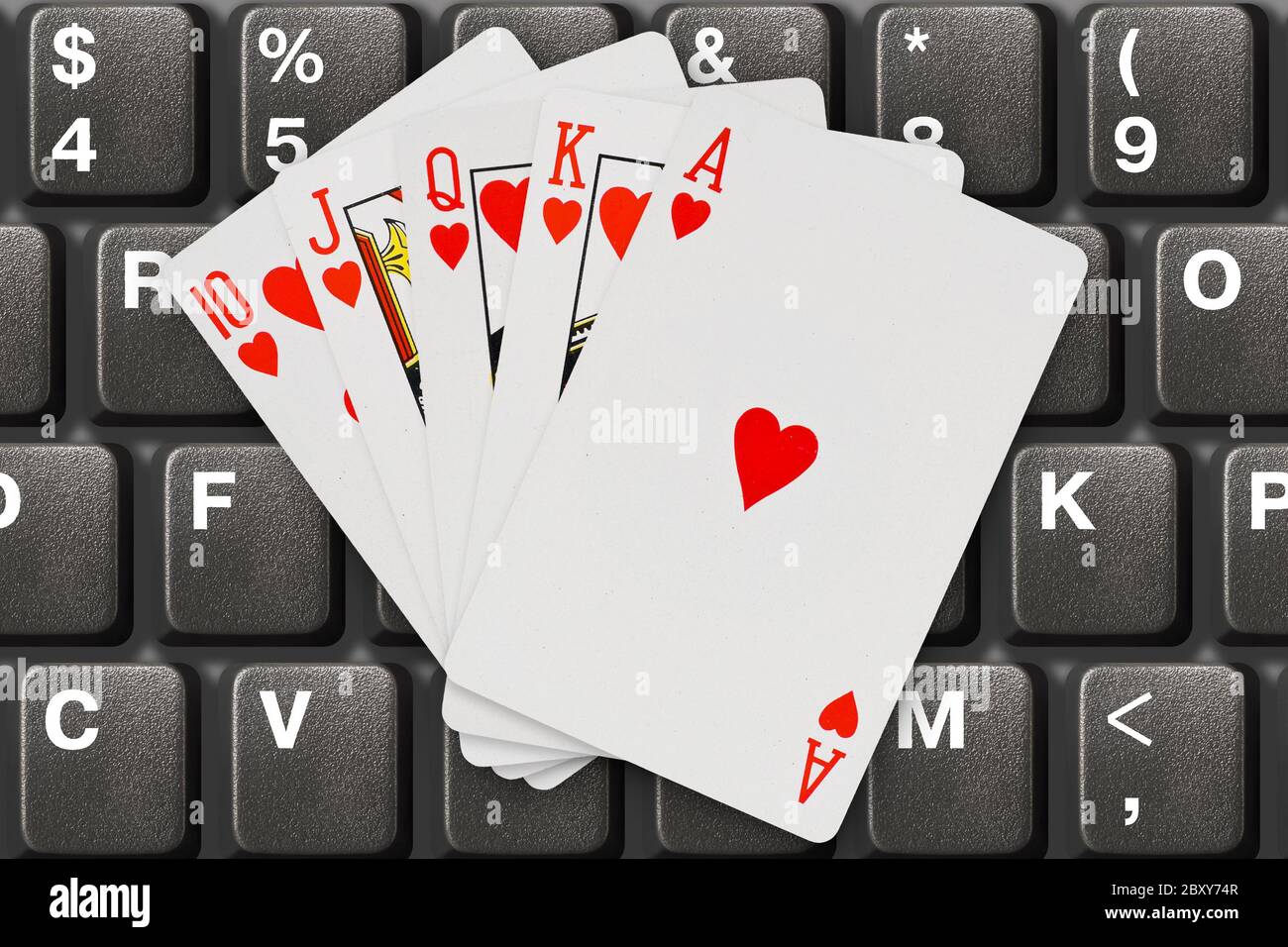 Playing cards on computer keyboard Stock Photo - Alamy