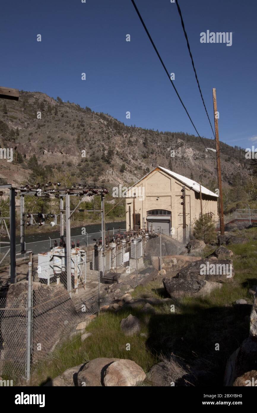 a power plant next to the river in the middle of the forest ...