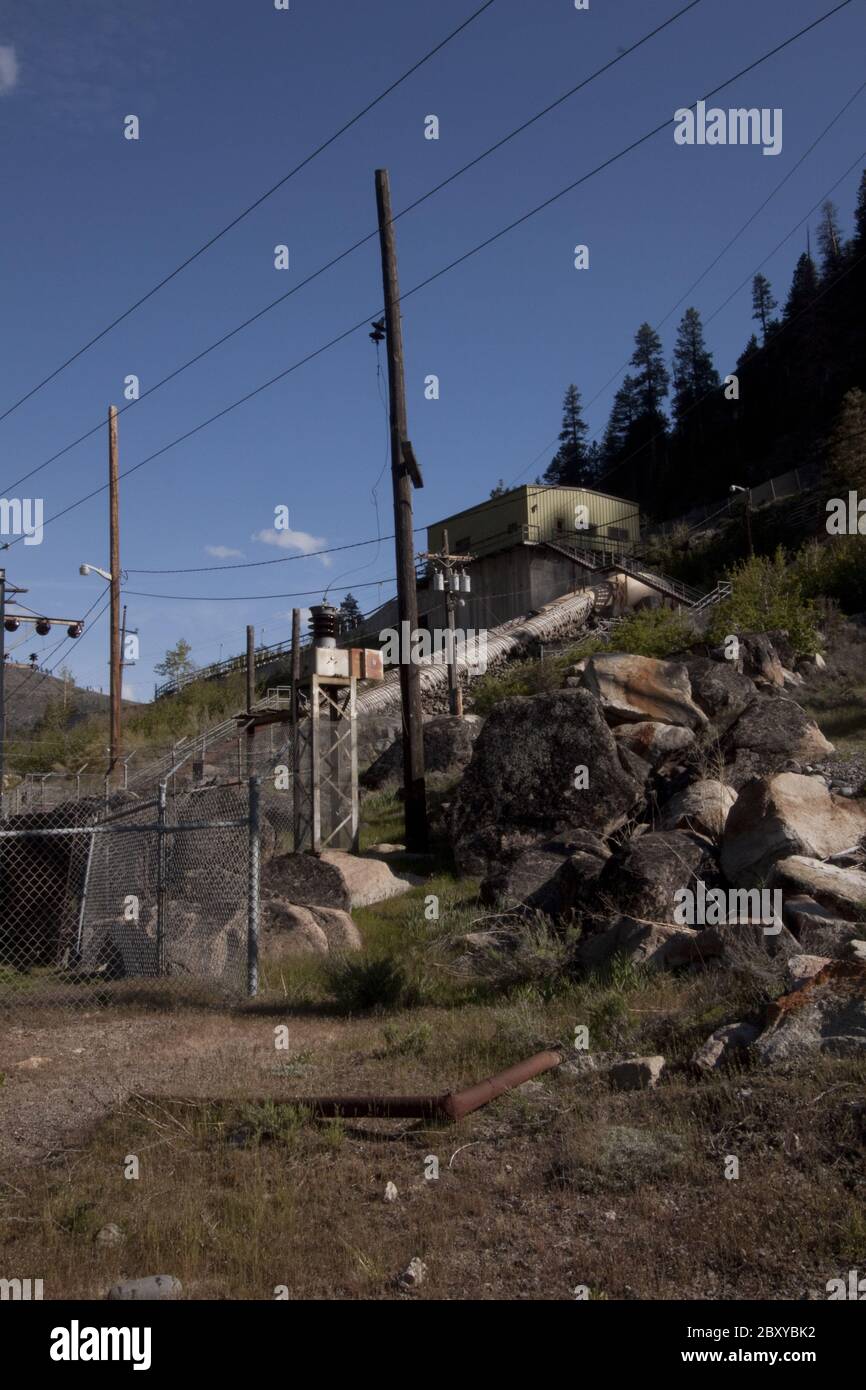 a power plant next to the river in the middle of the forest ...