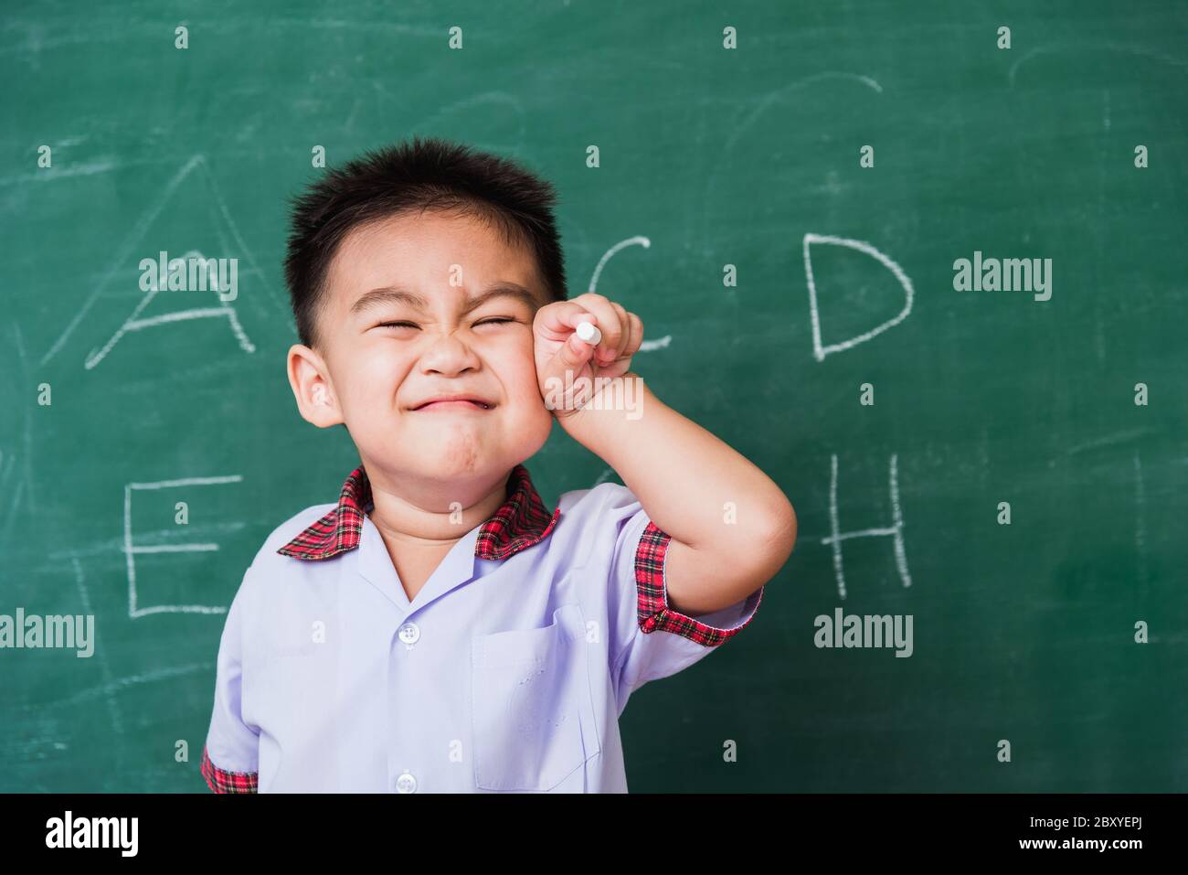 Back to School. Happy Asian funny cute little child boy kindergarten ...