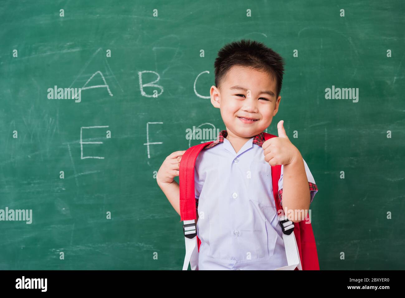 Back to School. Happy Asian funny cute little child boy kindergarten in ...