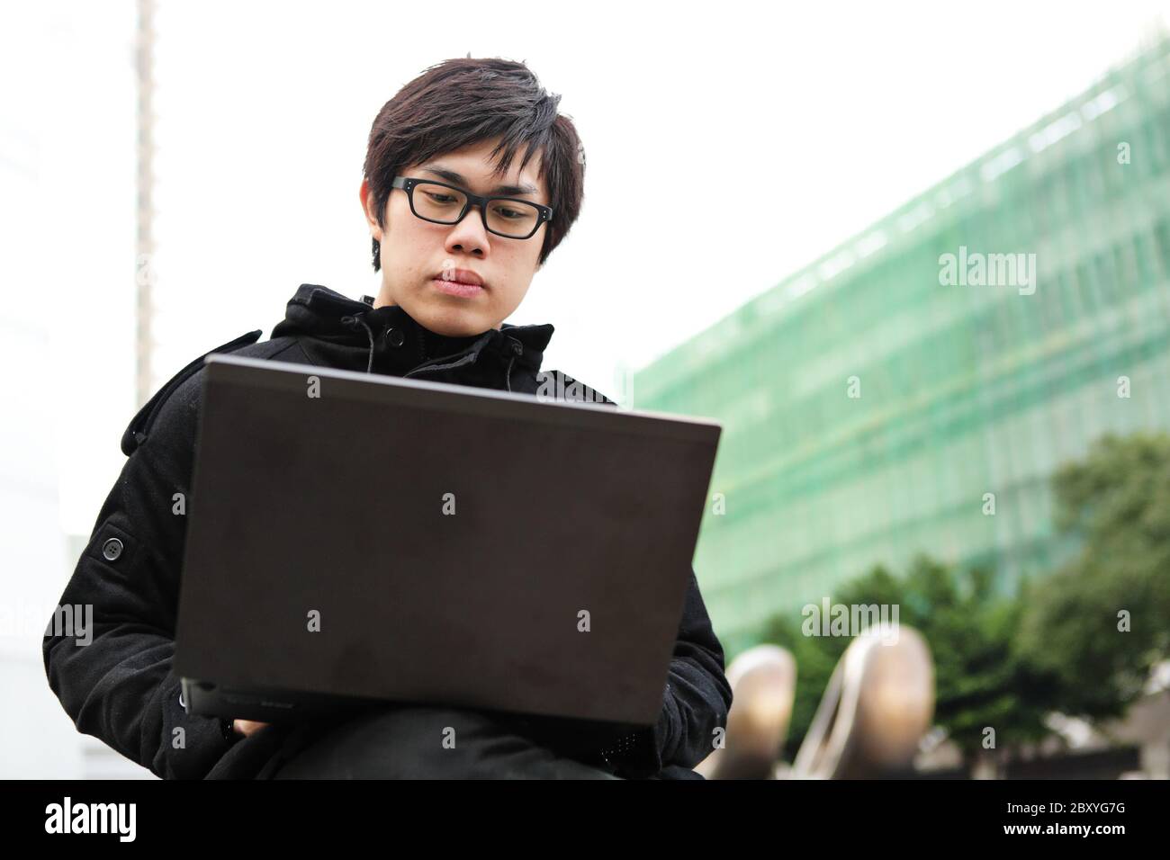 man using computer outdoor Stock Photo - Alamy