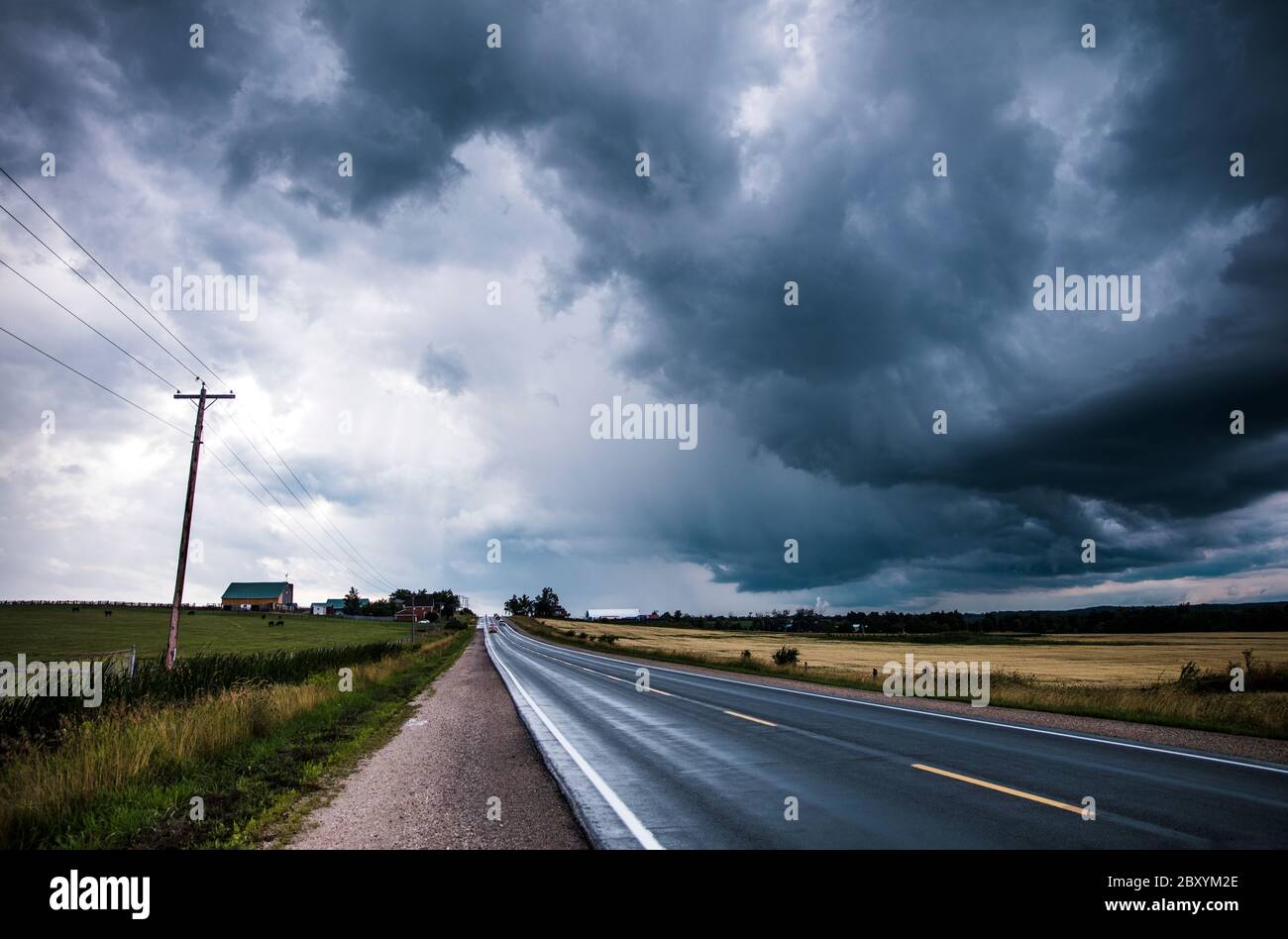 Dramatic thunder clouds and rain storm over rural highway road Stock ...