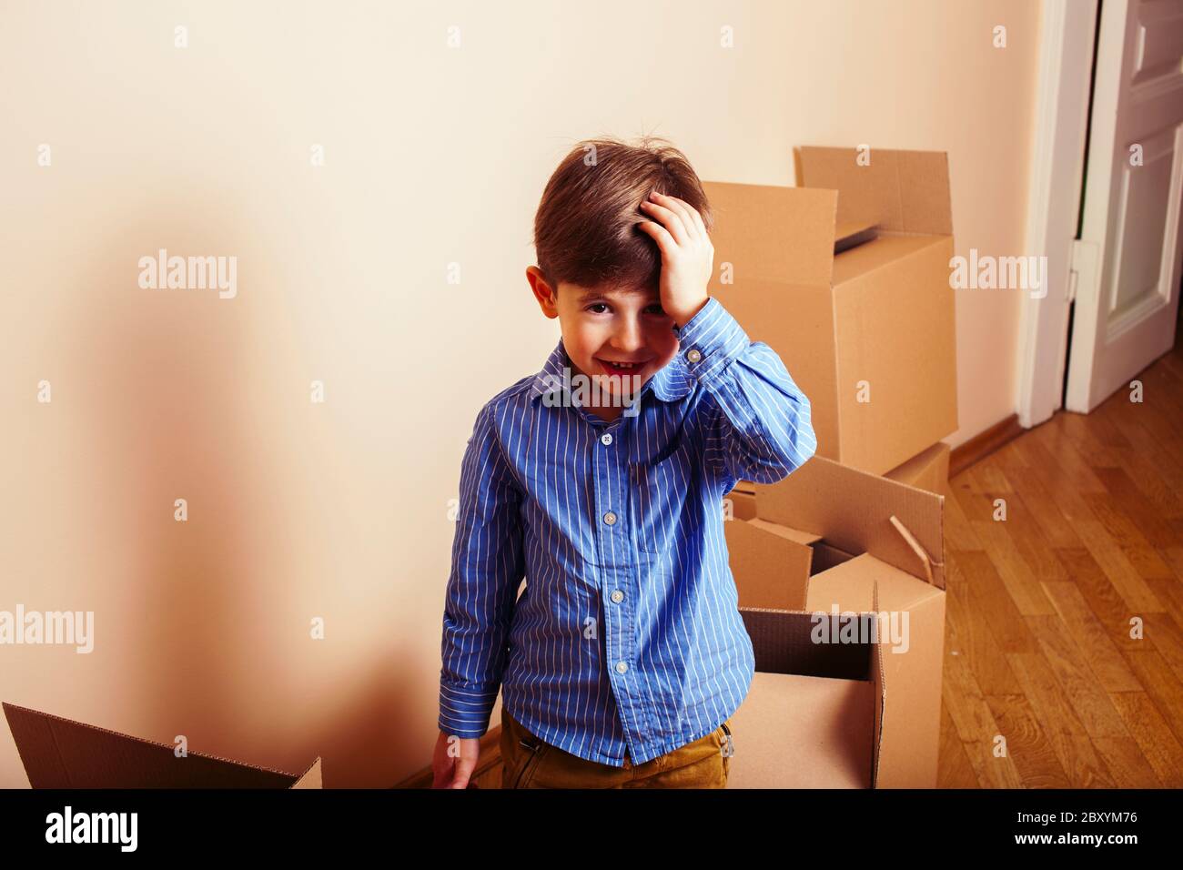 little cute boy in empty room, move to new house. home alone among ...