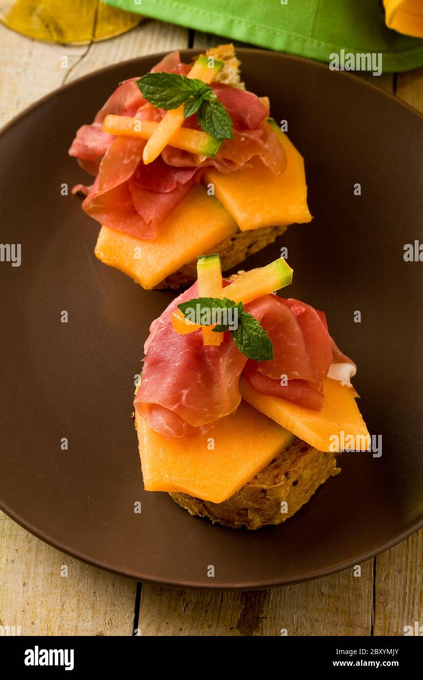 Ham and melon appetizer Stock Photo - Alamy