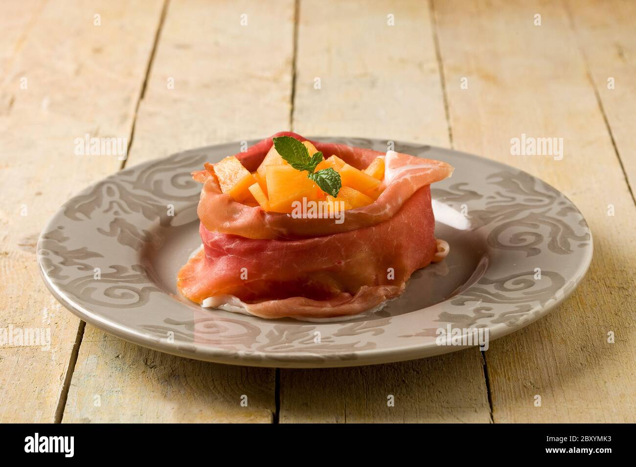 Ham and melon appetizer Stock Photo - Alamy
