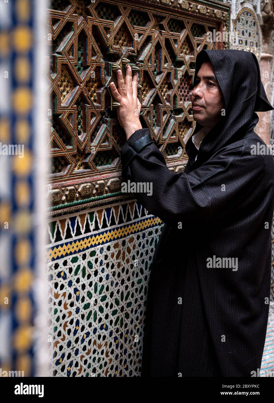 FEZ, MOROCCO - CIRCA MAY 2018: Moroccan man praying at the courtyard of ...