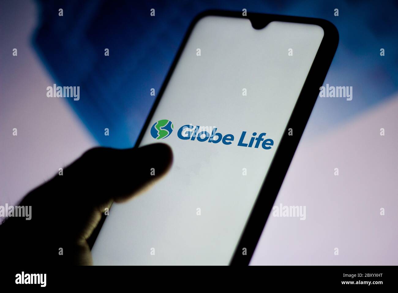 In this photo illustration the Globe Life logo seen displayed on a ...