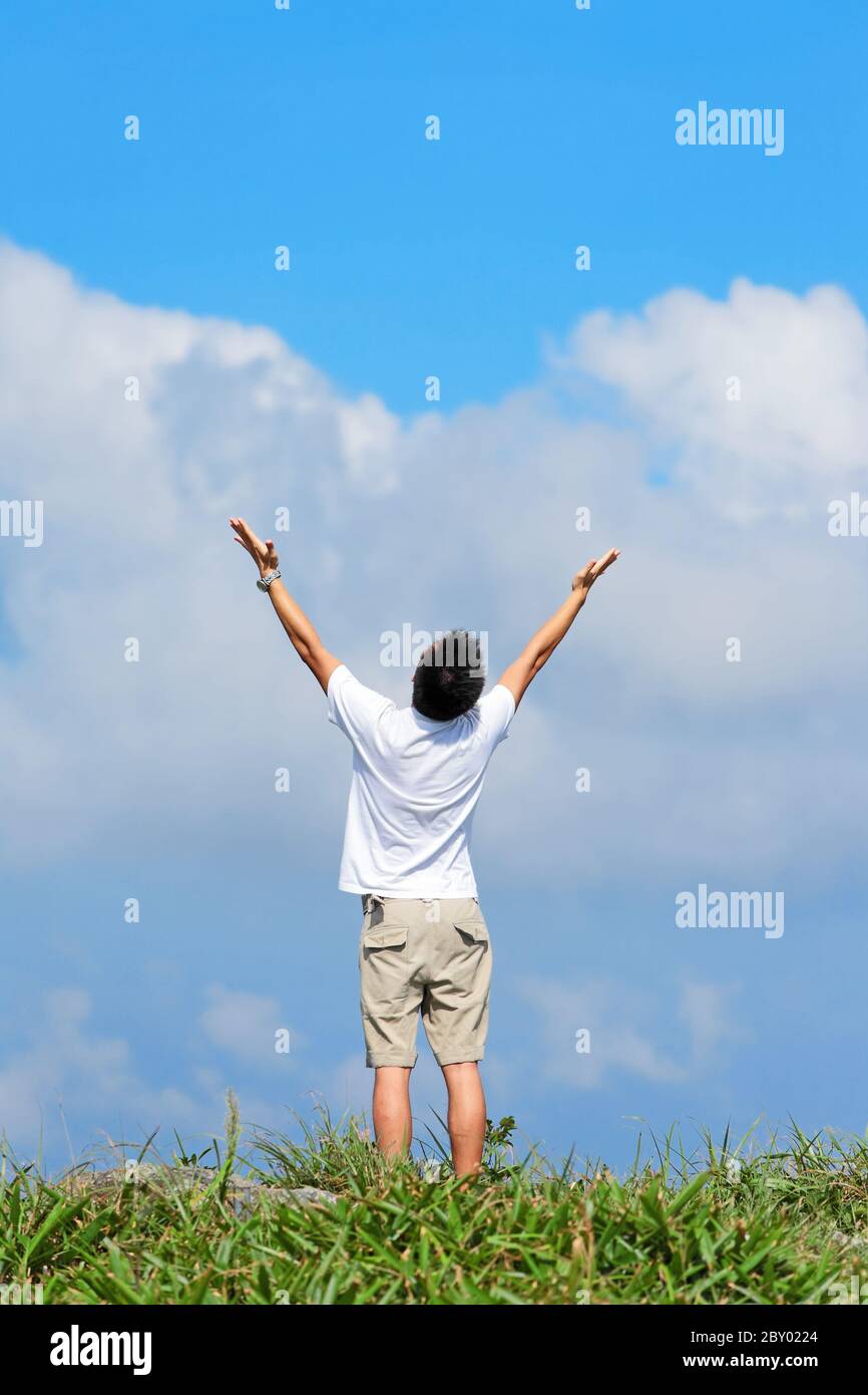 Man holding arms up Stock Photo - Alamy