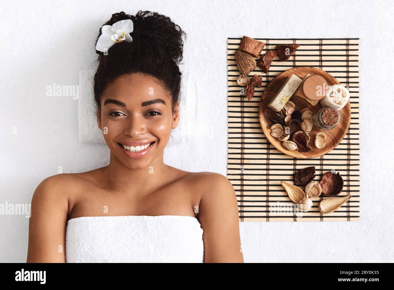 Cheerful african woman attending spa, top view Stock Photo - Alamy