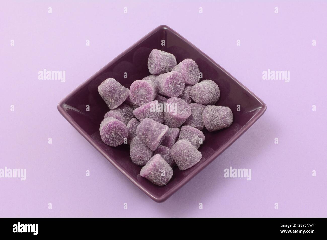 Purple gum spice drops in purple dessert bowl on lavender background ...
