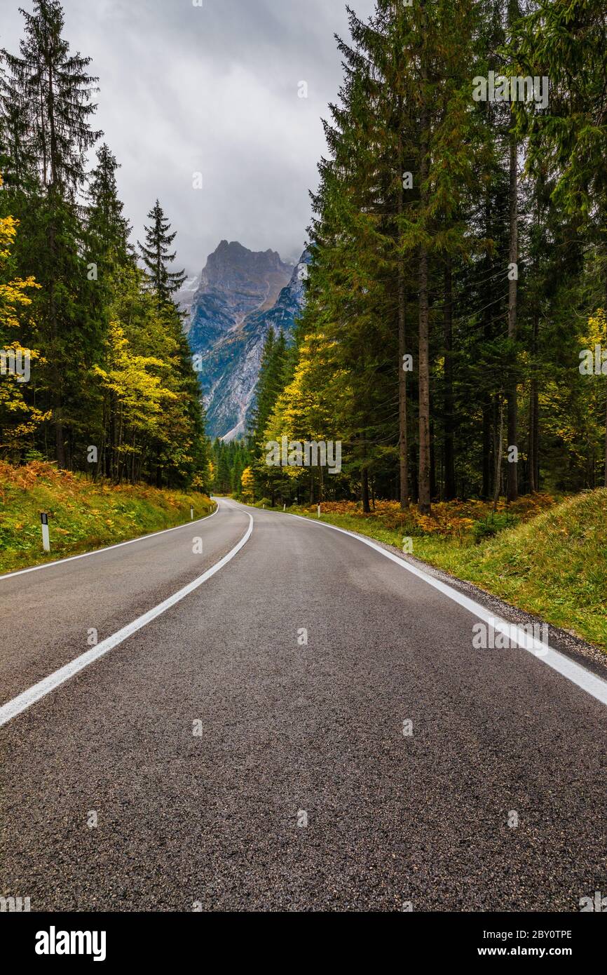Mountain road. Landscape with rocks, sunny sky with clouds and ...