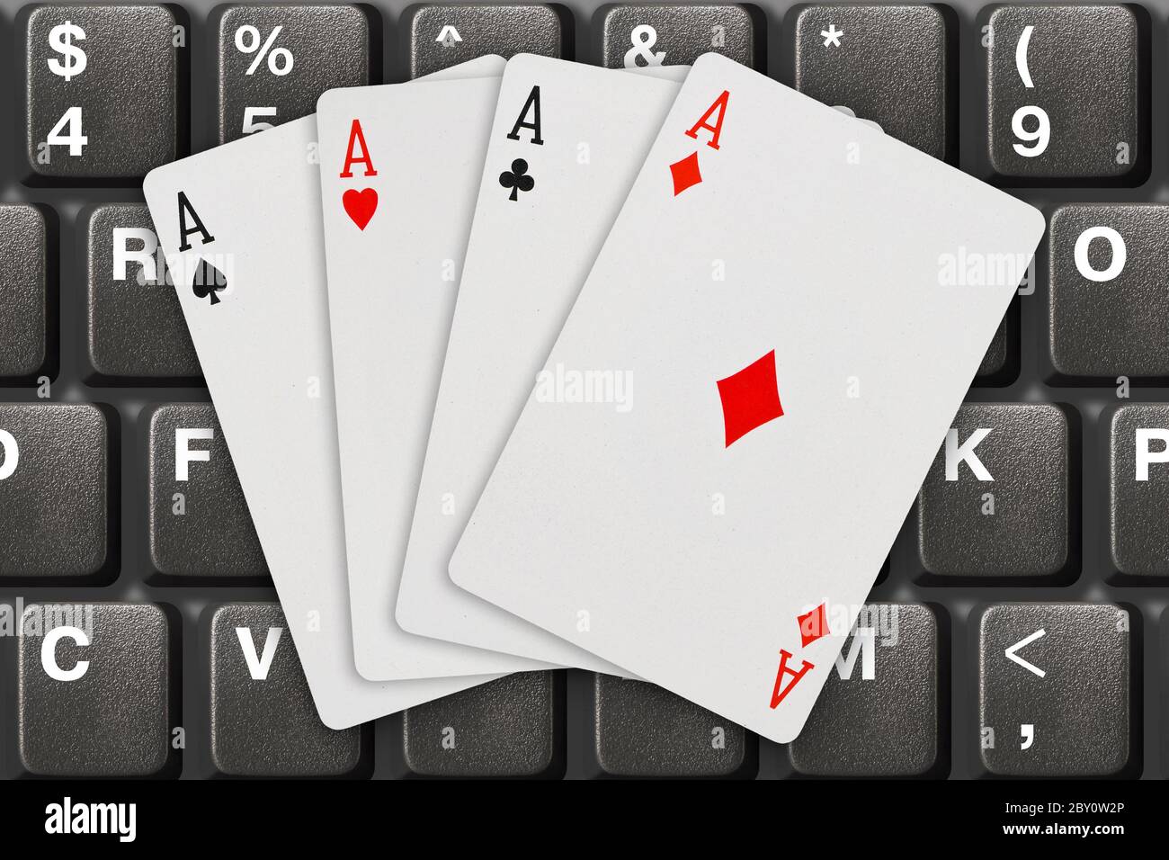 Playing cards on computer keyboard Stock Photo - Alamy