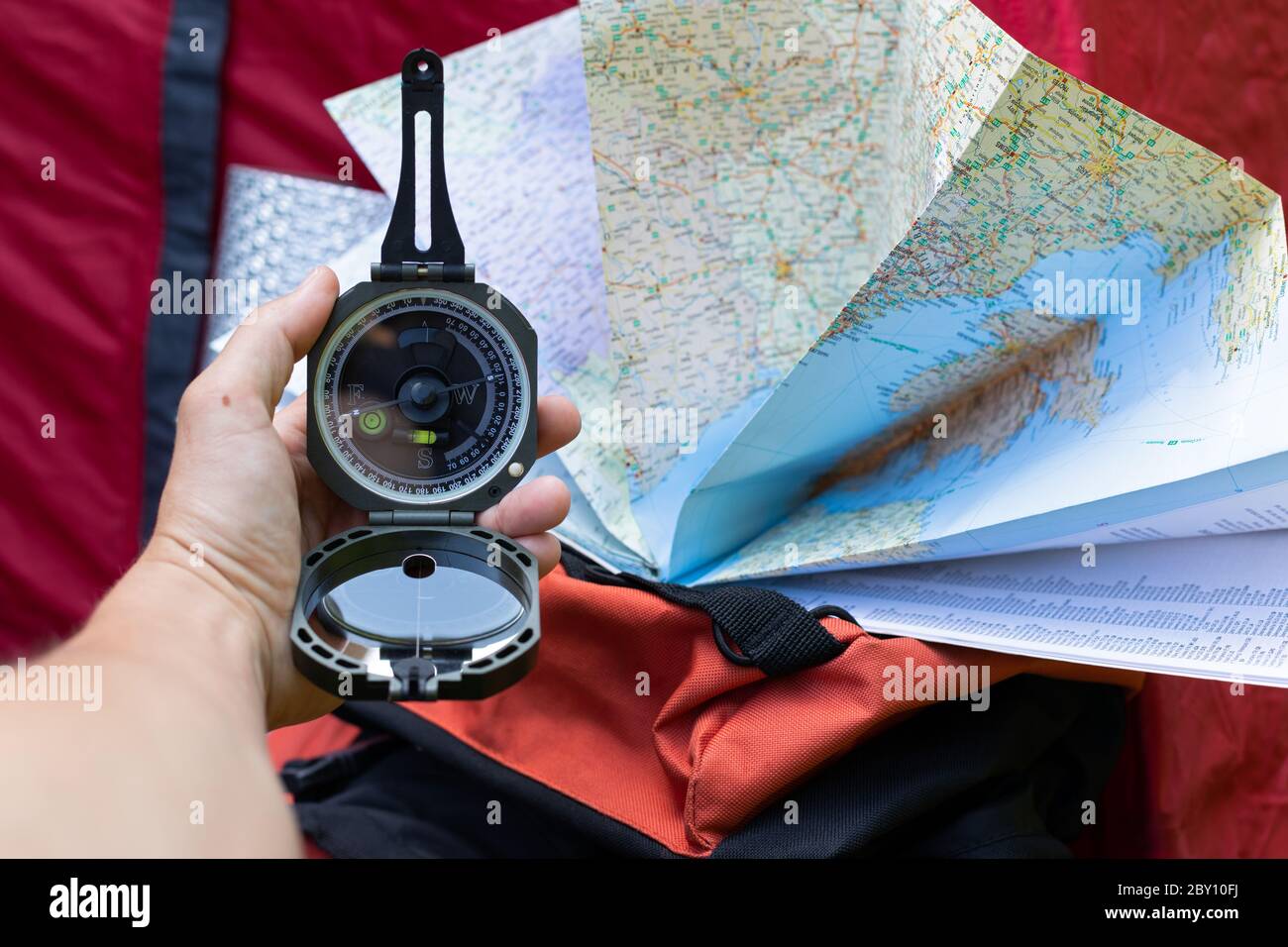 Close up picture of compass and map - preparing for camping trip in the ...