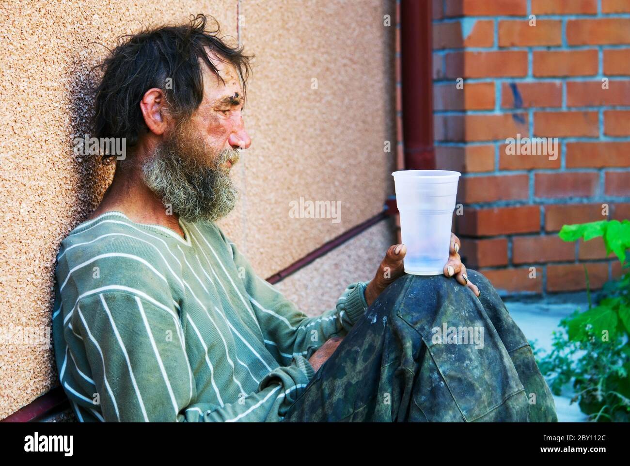 Homeless alcoholic in depression Stock Photo - Alamy