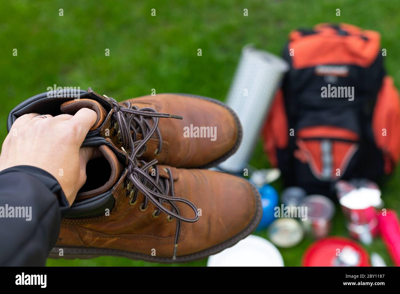 Picture of camping tools on the grass - backpack, tent, gas tank, cans ...