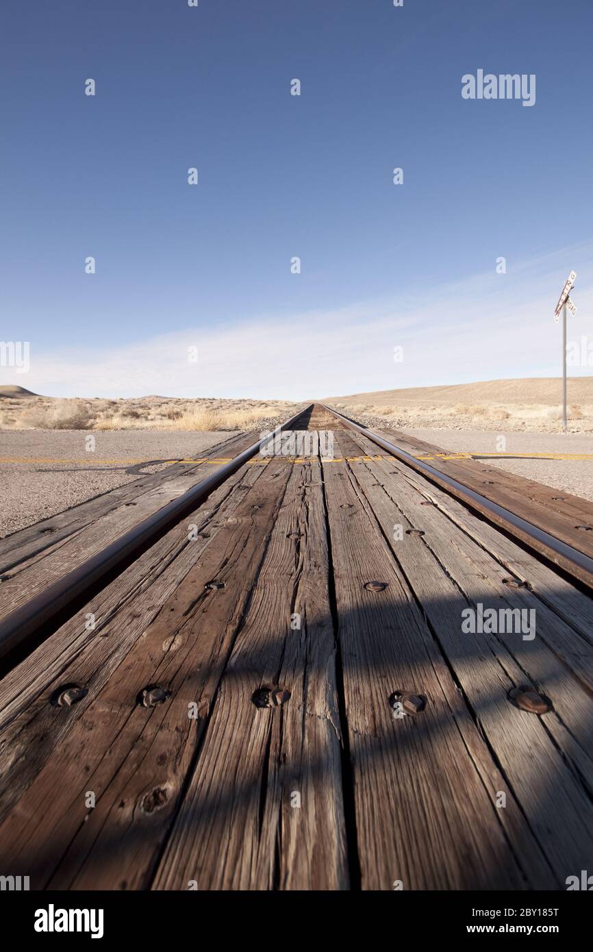 Railroad crossing tracks in the desert Stock Photo - Alamy