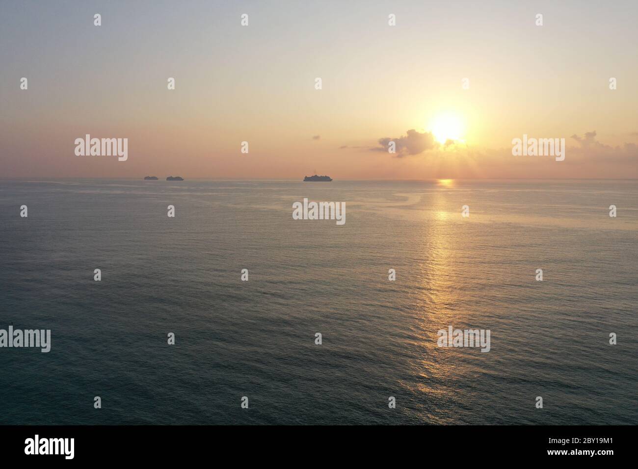 Aerial view of sunrise over ocean from Miami Beach, Florida with cruise ...