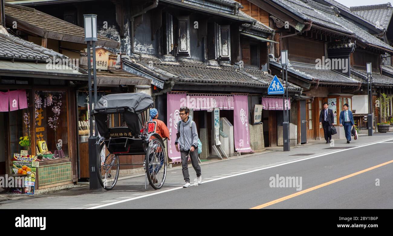 Rickshaw puller in traditional attire in the street of Kawagoe, Saitama ...
