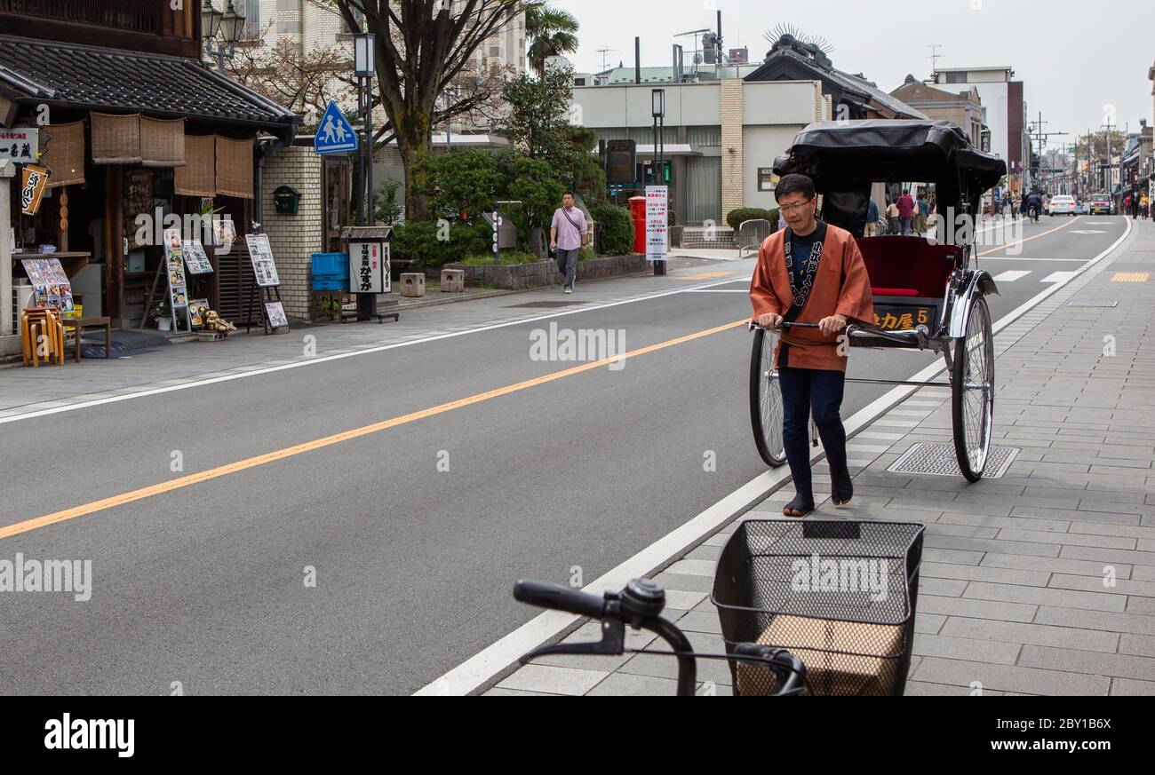 Rickshaw puller in traditional attire in the street of Kawagoe, Saitama ...