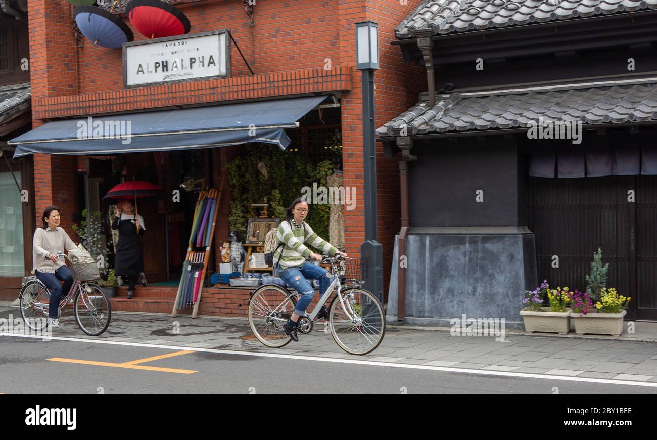 Japanese woman riding a bicycle hi-res stock photography and images - Alamy
