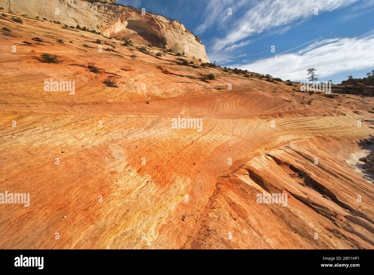 Orange striped slope and plumose clouds Stock Photo - Alamy