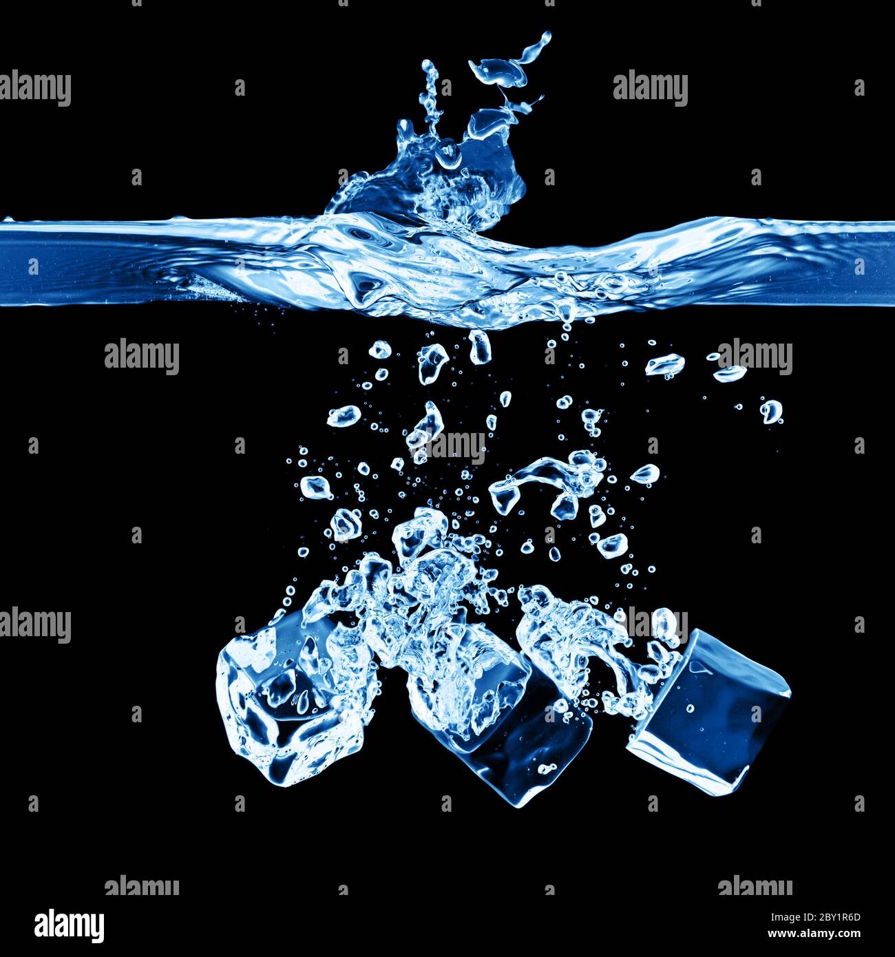 ice cube dropped, isolated on black Stock Photo - Alamy