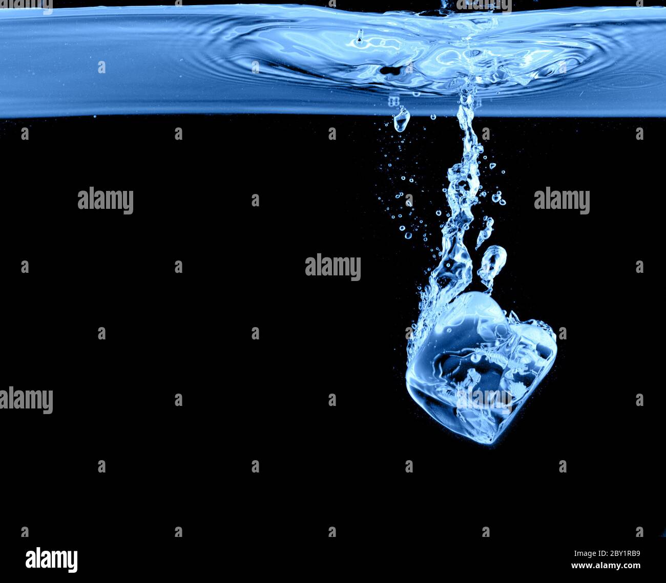 ice cube dropped, isolated on black Stock Photo - Alamy