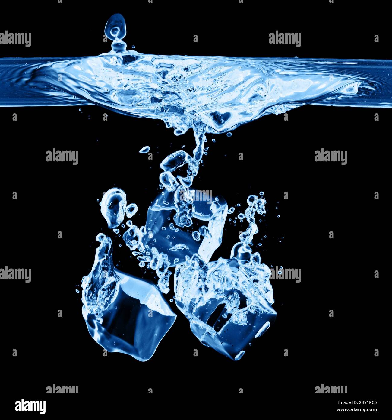 ice cube dropped, isolated on black Stock Photo - Alamy