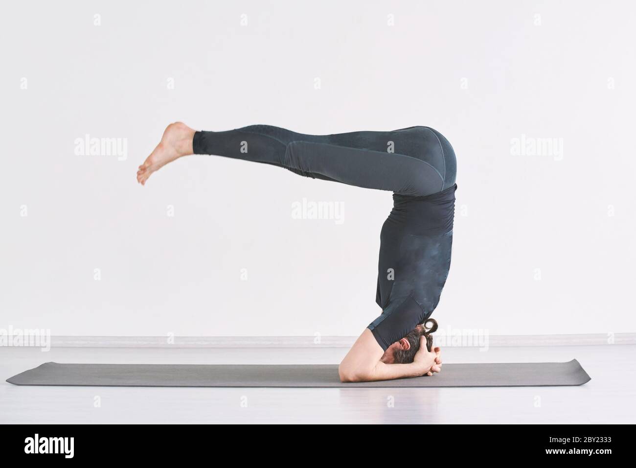 Headstand yoga asana. Man morning exercise at home Stock Photo - Alamy