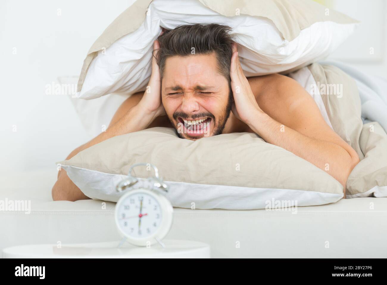 tired man in the bed not happy Stock Photo - Alamy