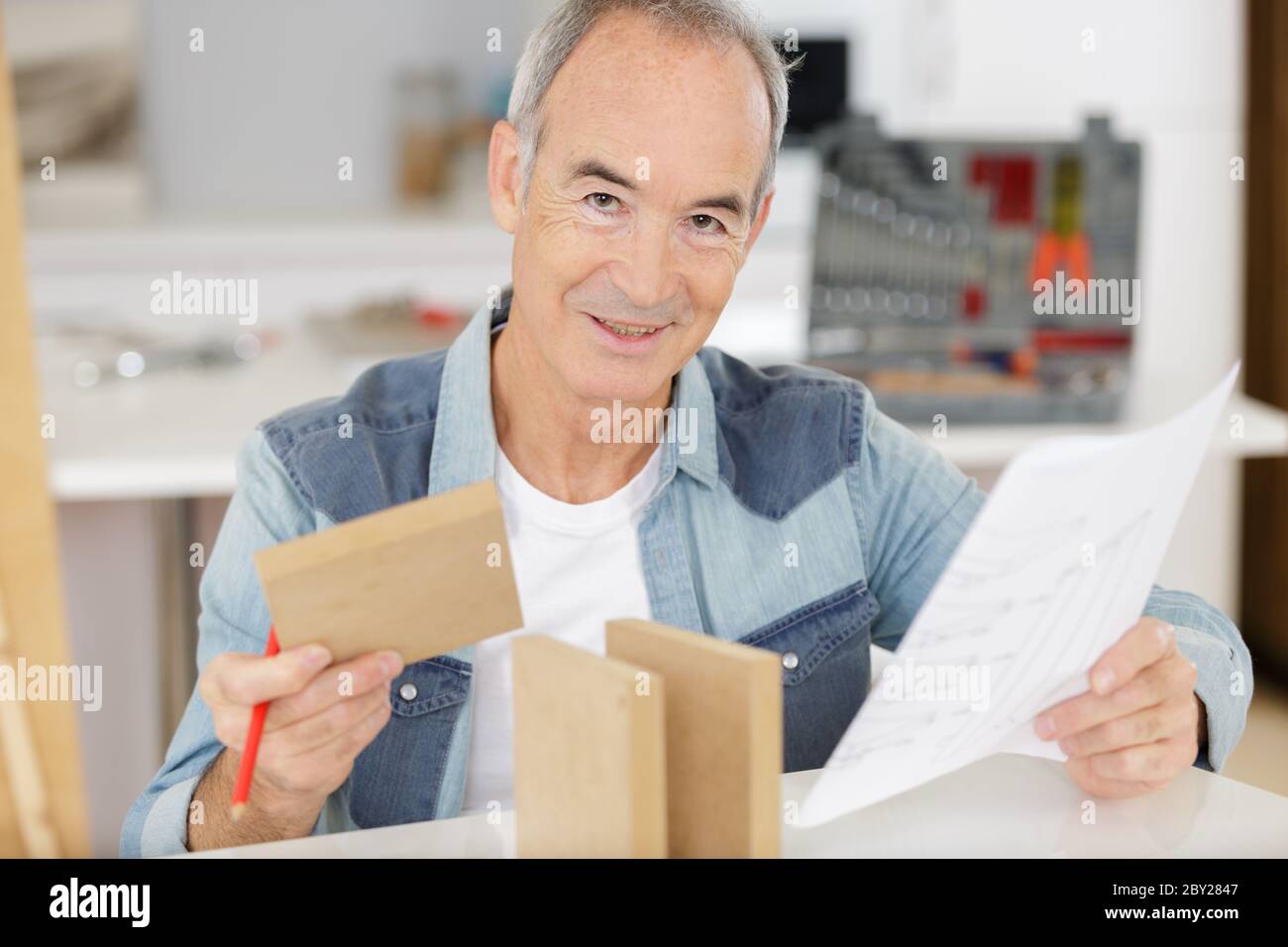 a senior man doing diy Stock Photo - Alamy