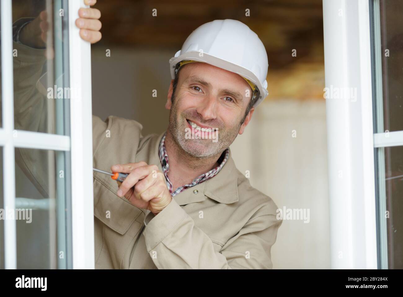 happy smiling constructor fixing a window Stock Photo - Alamy happy smiling constructor fixing a window Stock Photo - Alamy