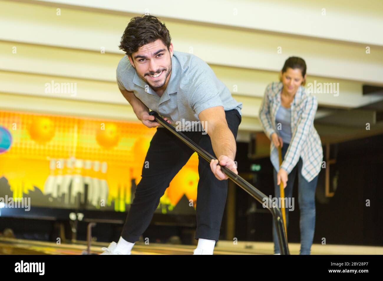 portrait of man cleaning bowling alley Stock Photo - Alamy