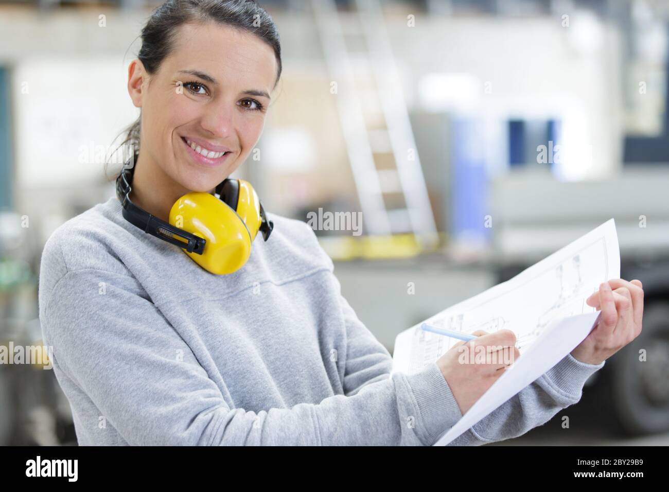 confident young worker taking necessary notes Stock Photo - Alamy