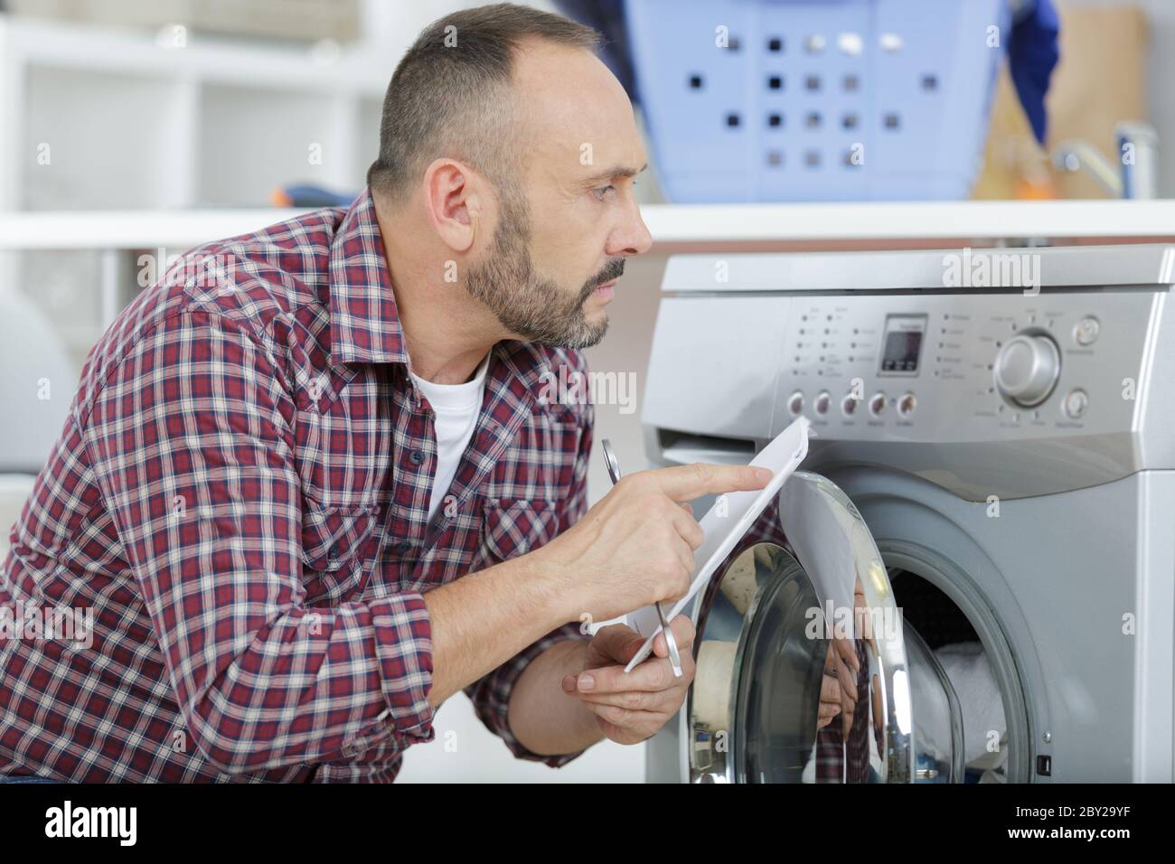 technician repairing a washing machine Stock Photo - Alamy