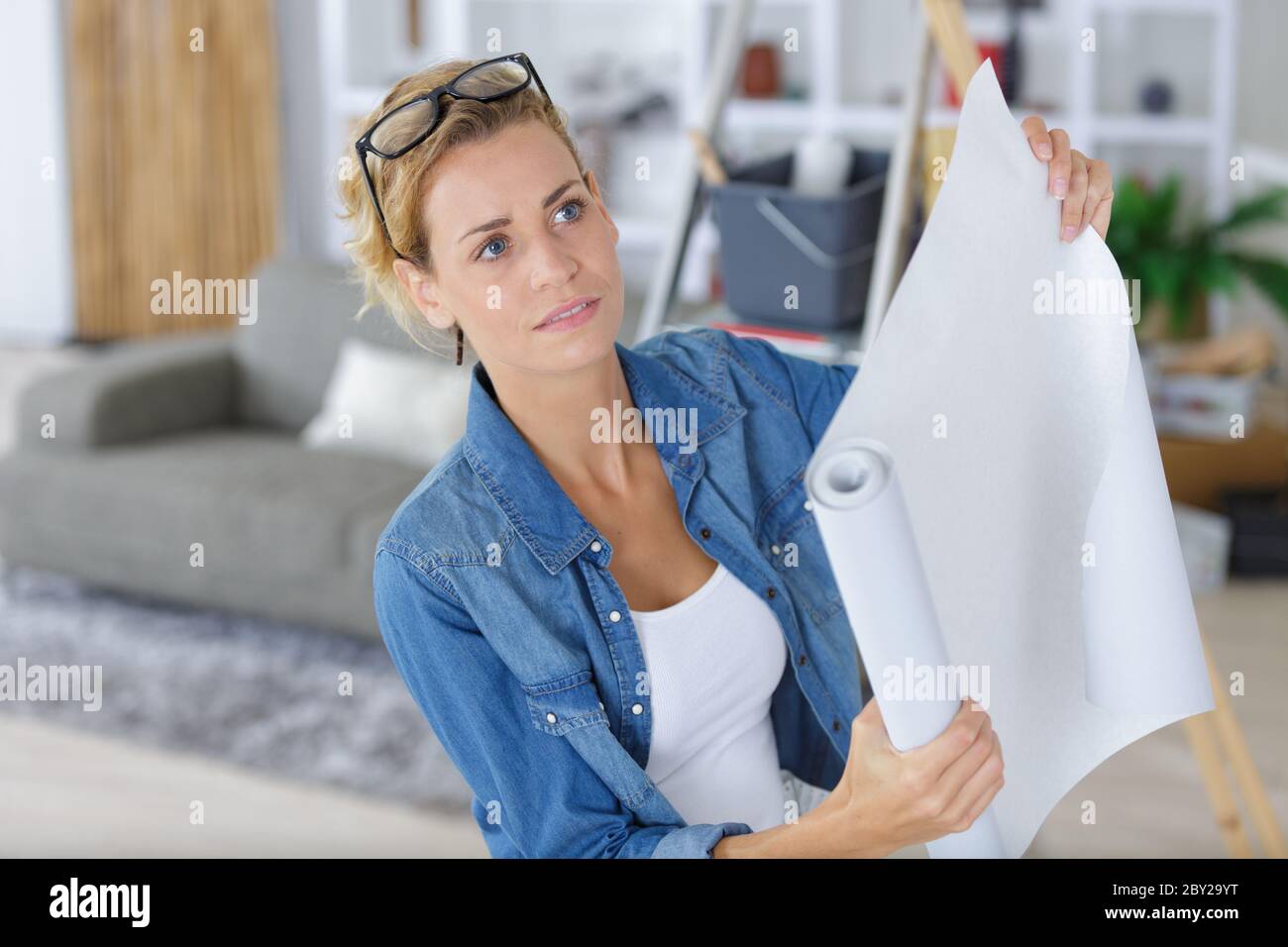 woman holding a roll of wallpaper Stock Photo - Alamy