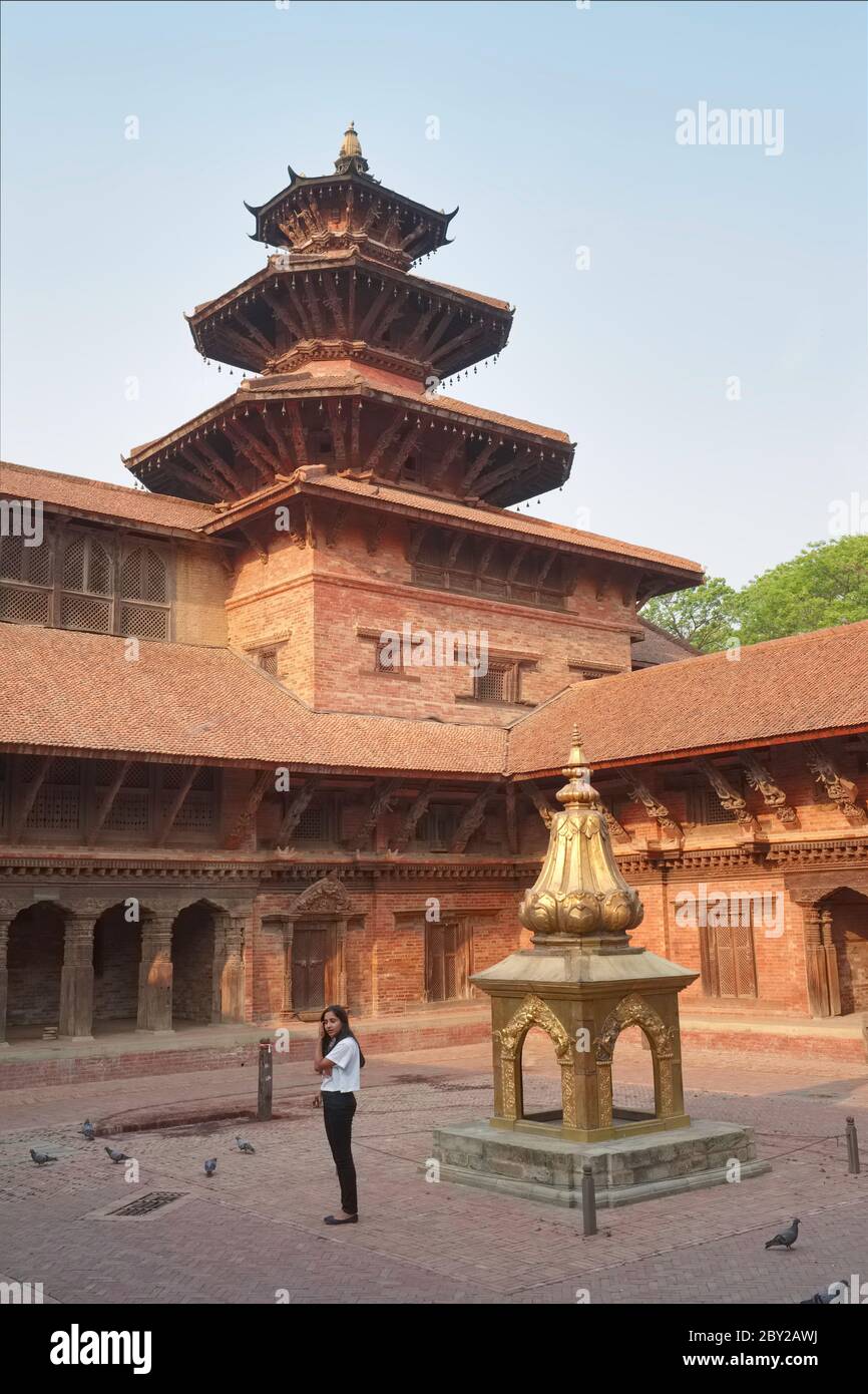 A young female visitor stands in Mul Chowk, a kind of courtyard in the ...