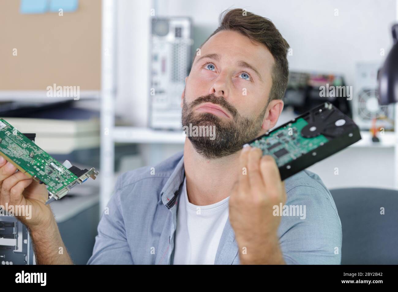 lab engineer holding broken hard disk Stock Photo - Alamy