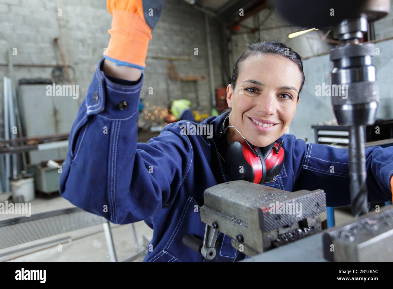 female engineer using drill in factory Stock Photo - Alamy