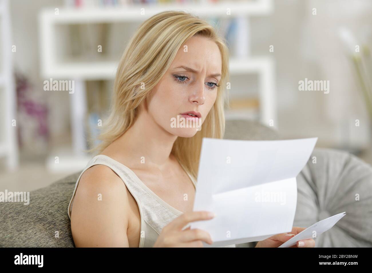 a woman reading a letter Stock Photo - Alamy