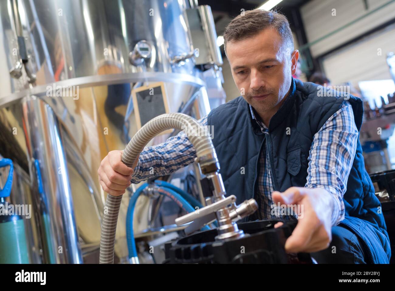 serviceman operating industrial water purification Stock Photo - Alamy