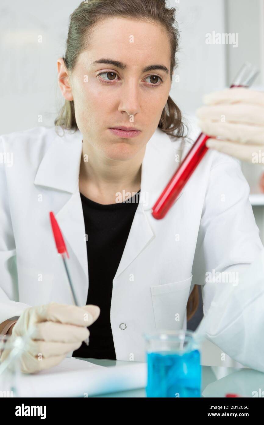 laboratory personnel analyzing the red liquid in the tube Stock Photo ...