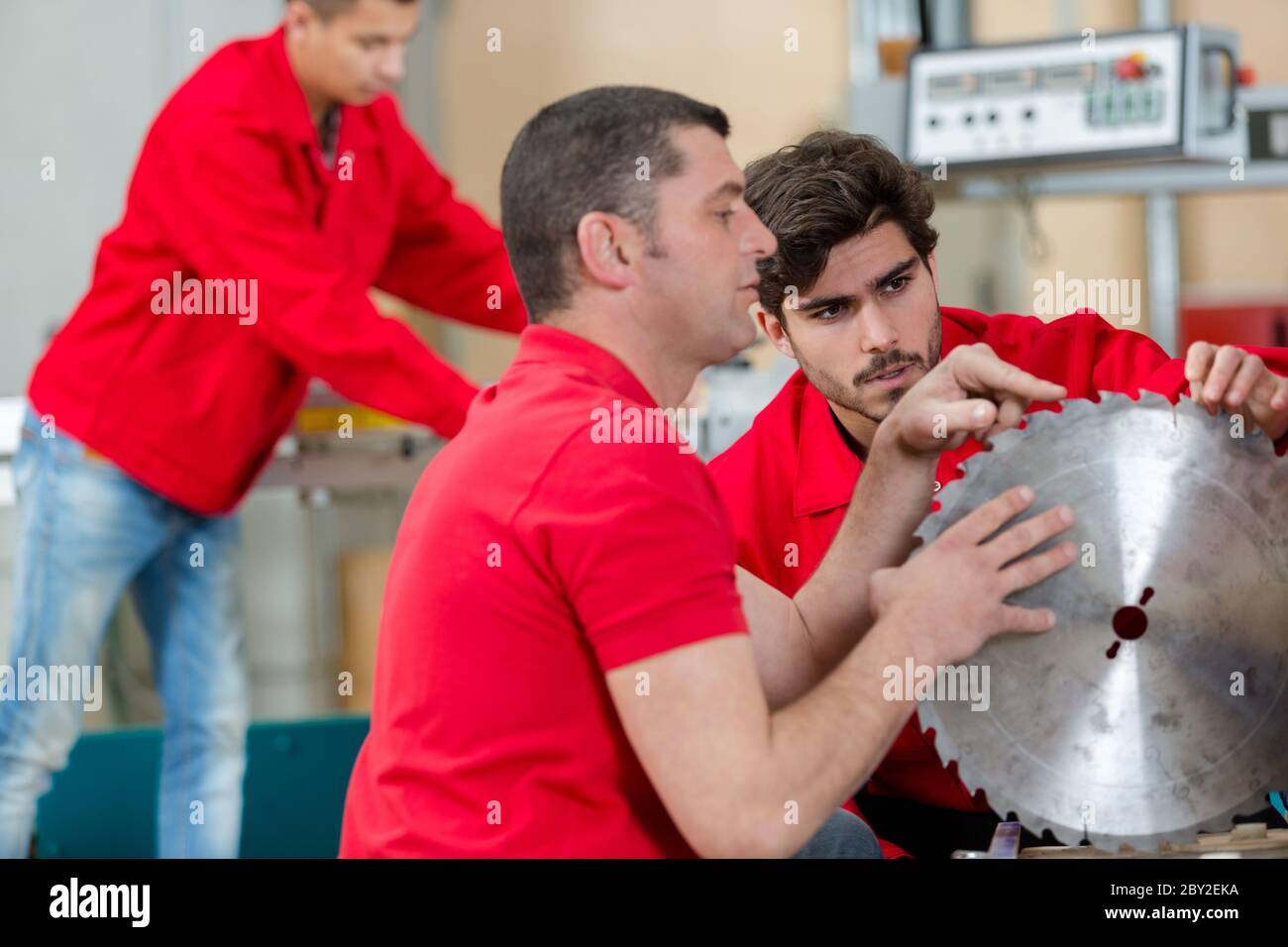 professional carpenter show sawing blade to apprentice Stock Photo - Alamy